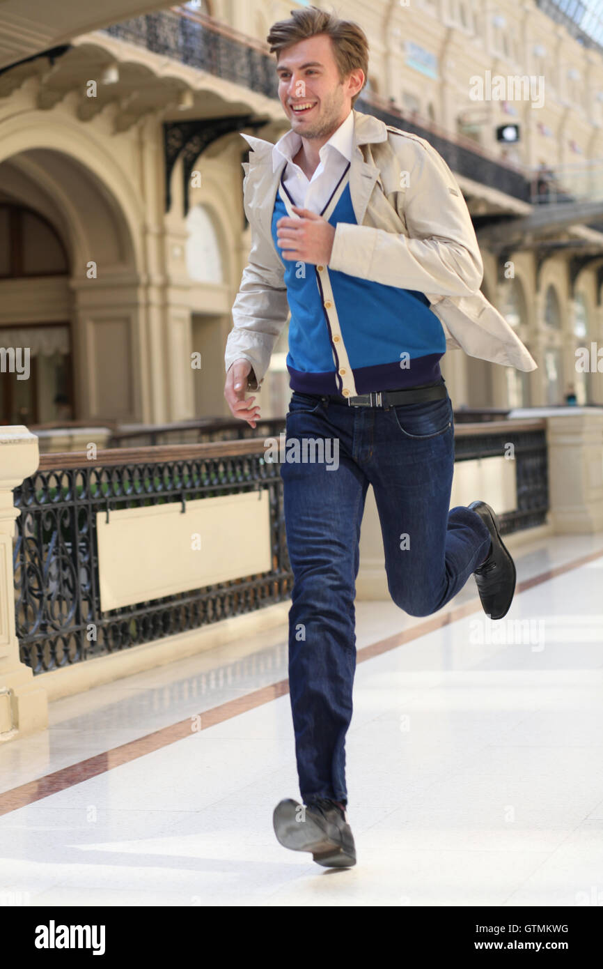 Young man running in the store Stock Photo - Alamy