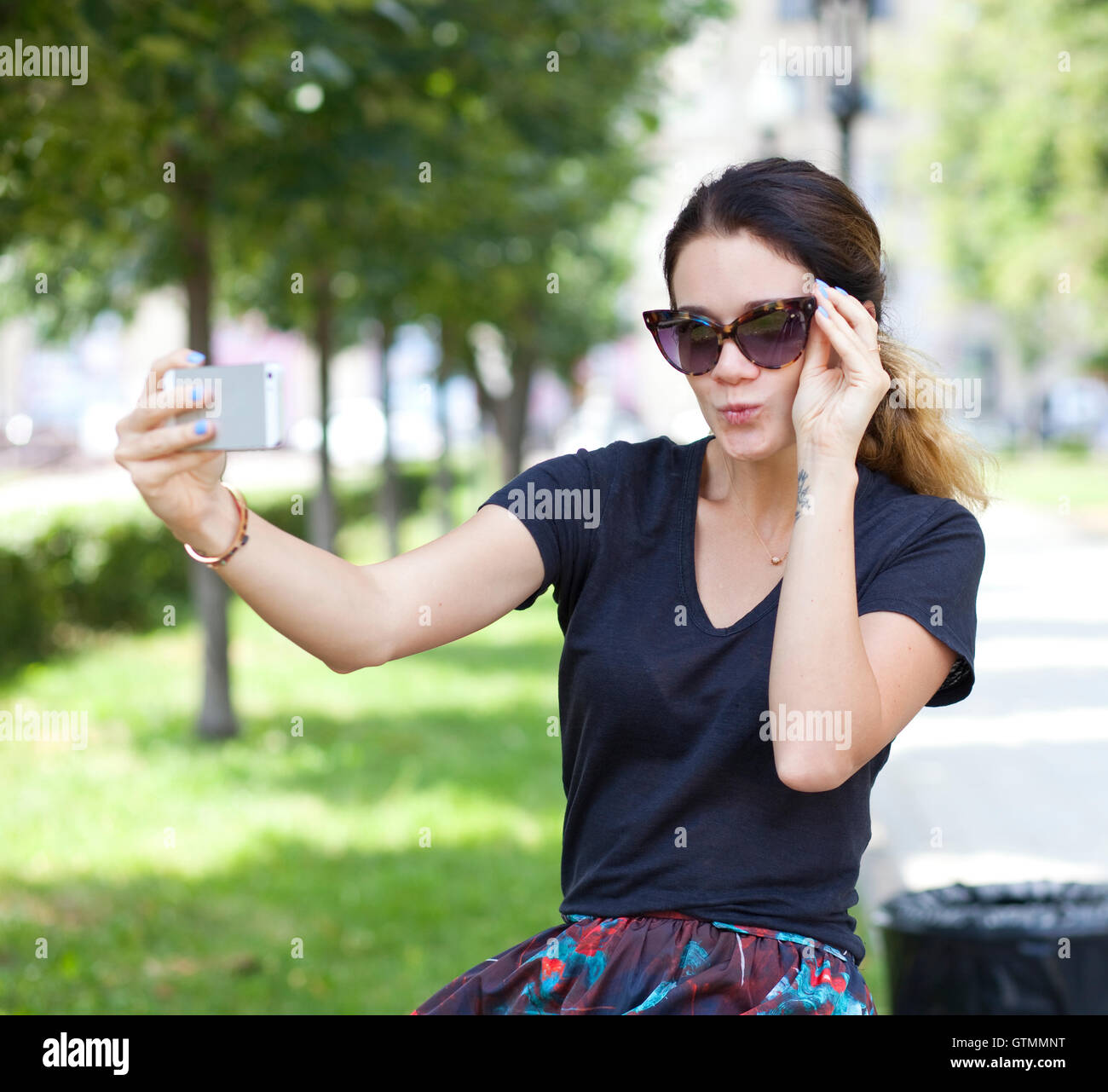 Happy young woman taking pictures on your phone Stock Photo - Alamy