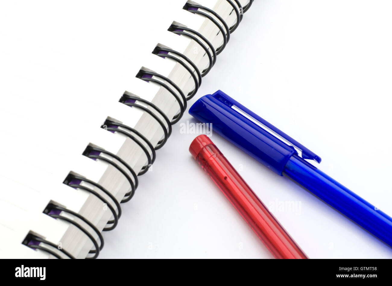 red and blue pen with notebook isolated on white Stock Photo - Alamy