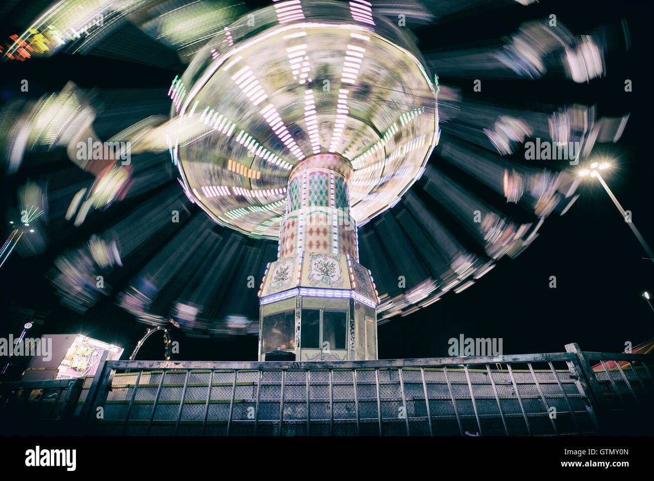 swing ride at carnival fair with blur motion effect Stock Photo - Alamy