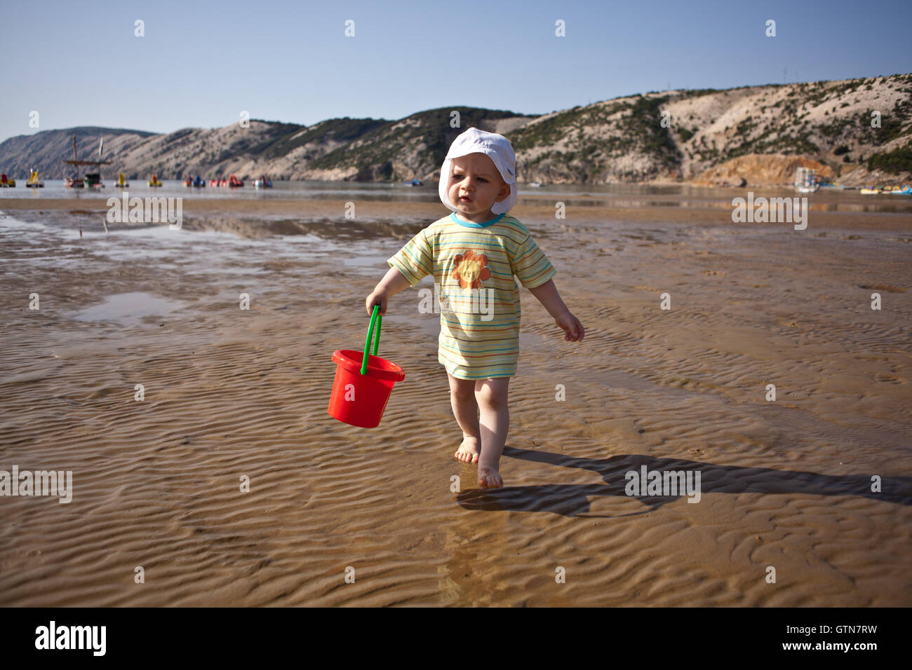 Boy running sand bucket hi-res stock photography and images - Alamy