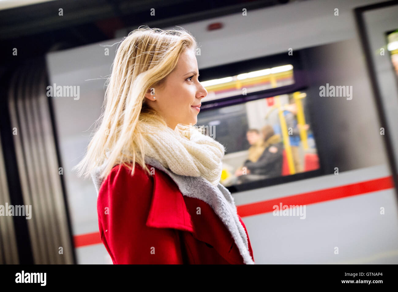 Beautiful young woman at the underground platform, waiting Stock Photo ...