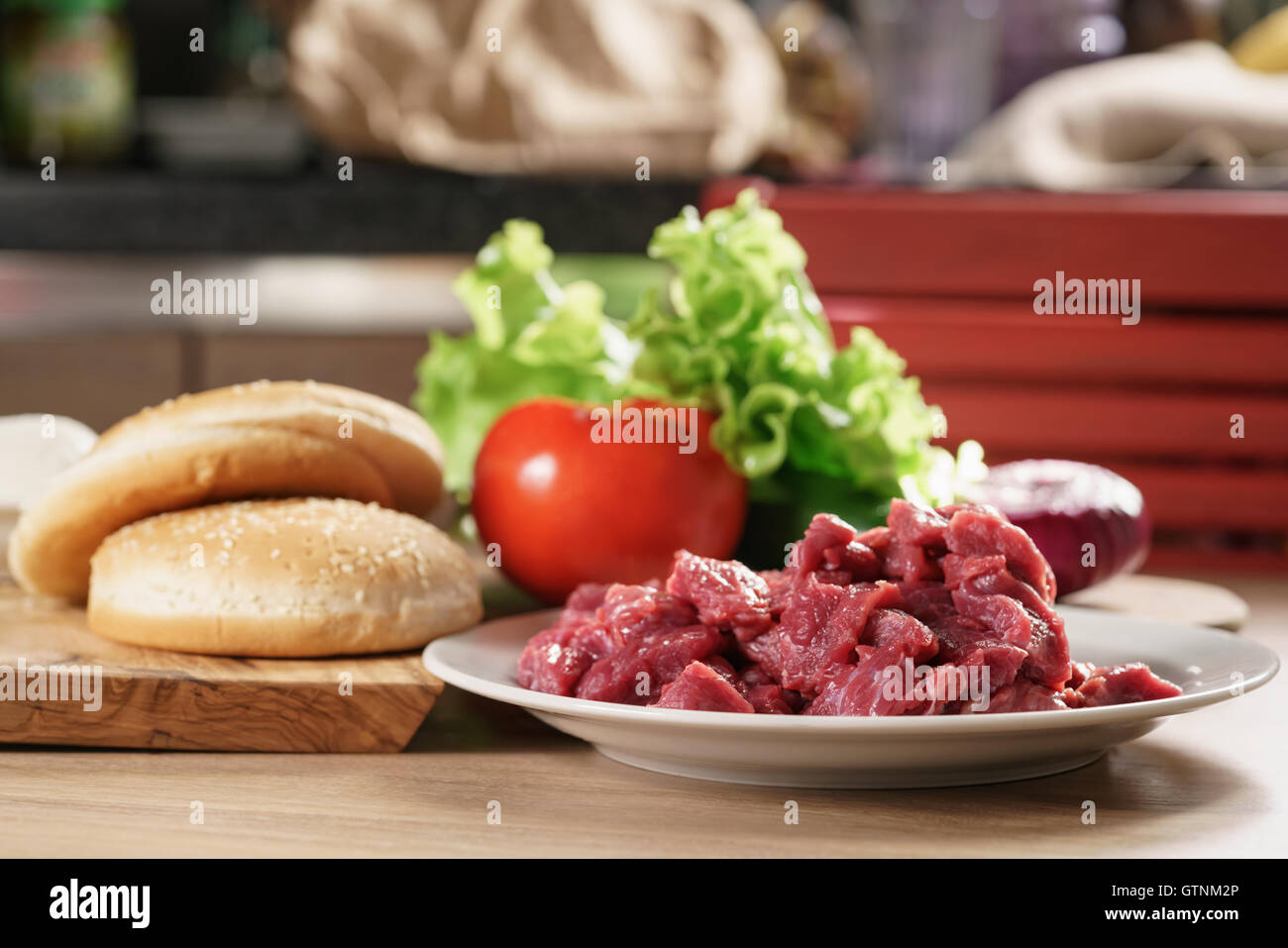 ingredients for burger on kitchen table Stock Photo - Alamy