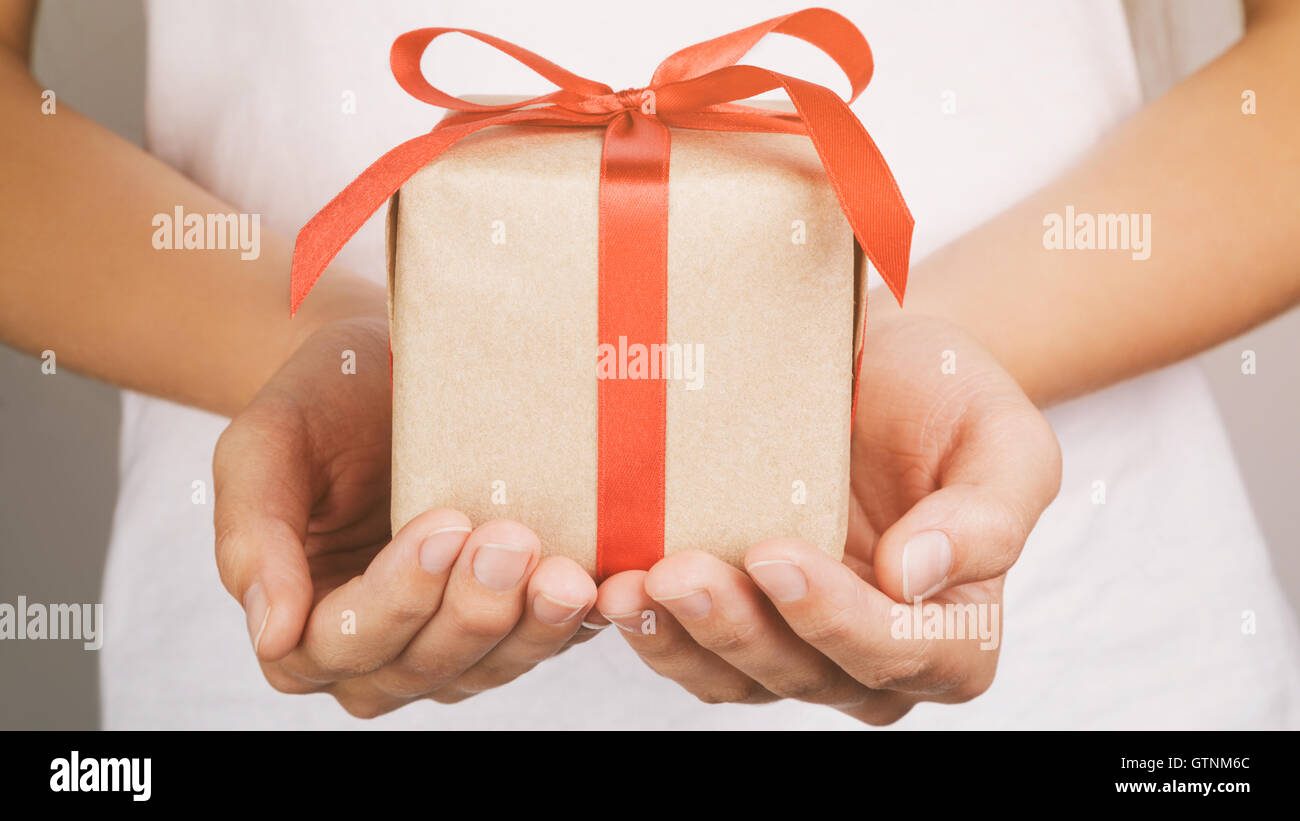 Hands holding gift box hi-res stock photography and images - Alamy