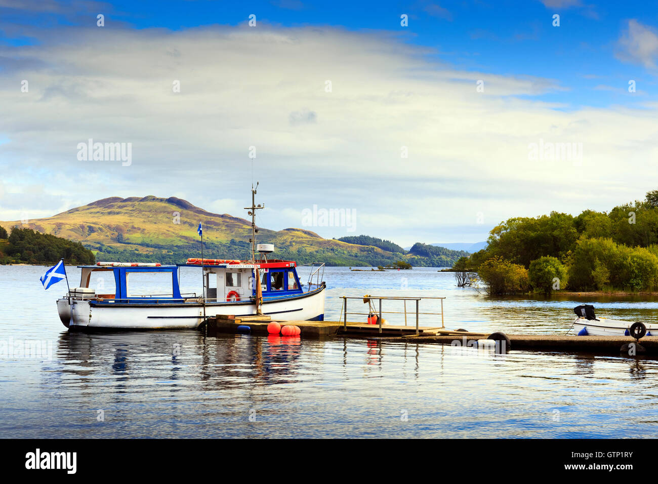 Small ferry at a pier on Loch lomond, Luss, Scotland, UK Stock Photo ...