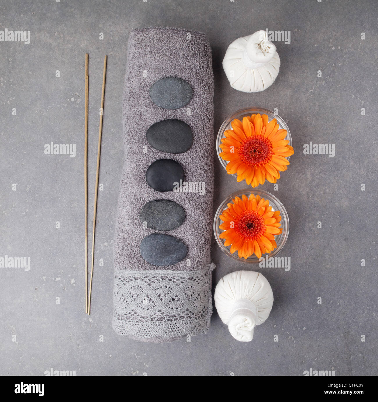Spa massage setting with rolled towel, thai herbal compress balls and ...