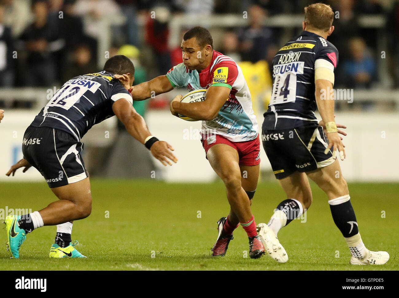 Harlequins' Joe Marchant is tackled by Sale Sharks' Johnny Leota ...