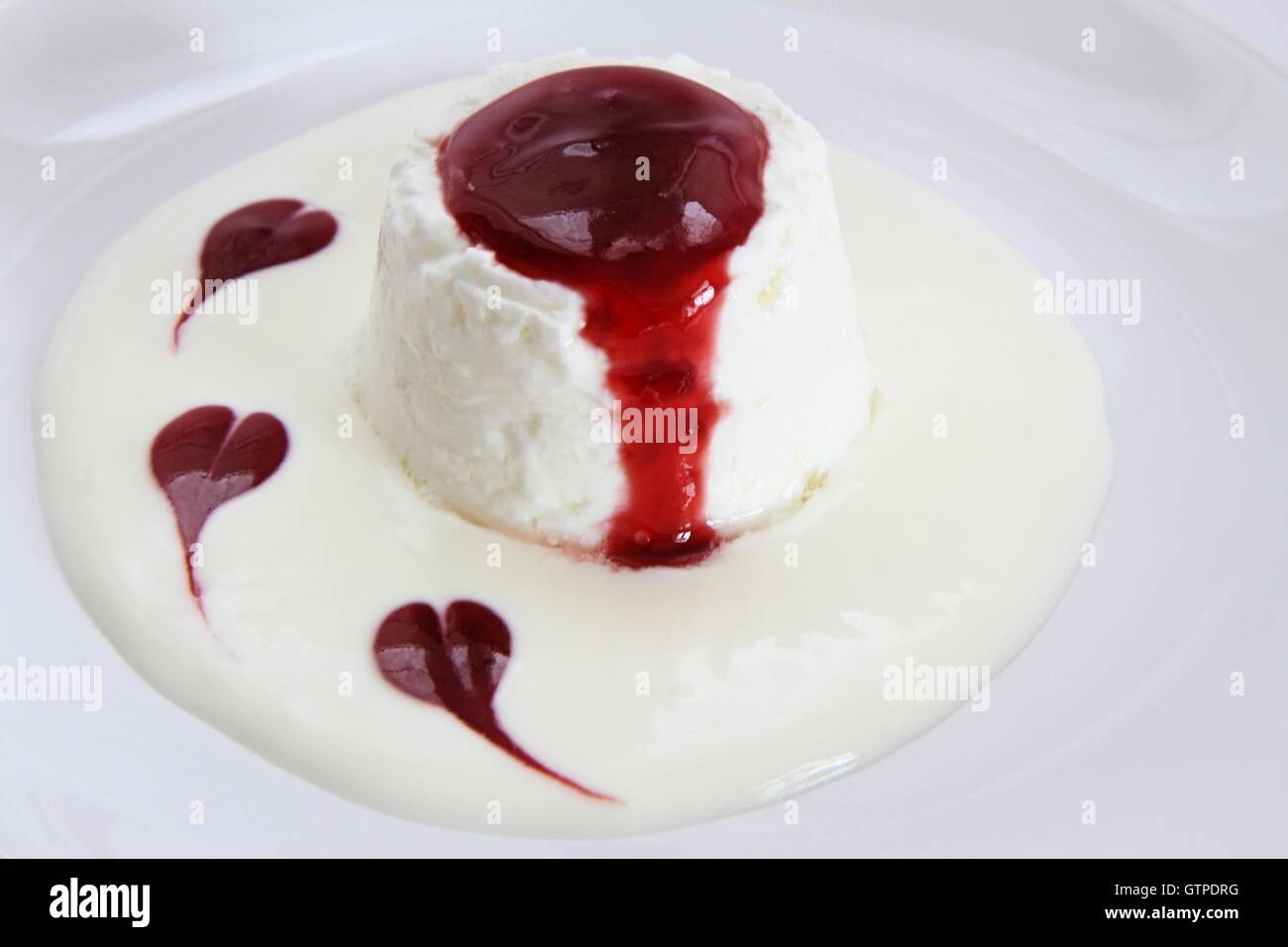 Faisselle with raspberry coulis Stock Photo - Alamy