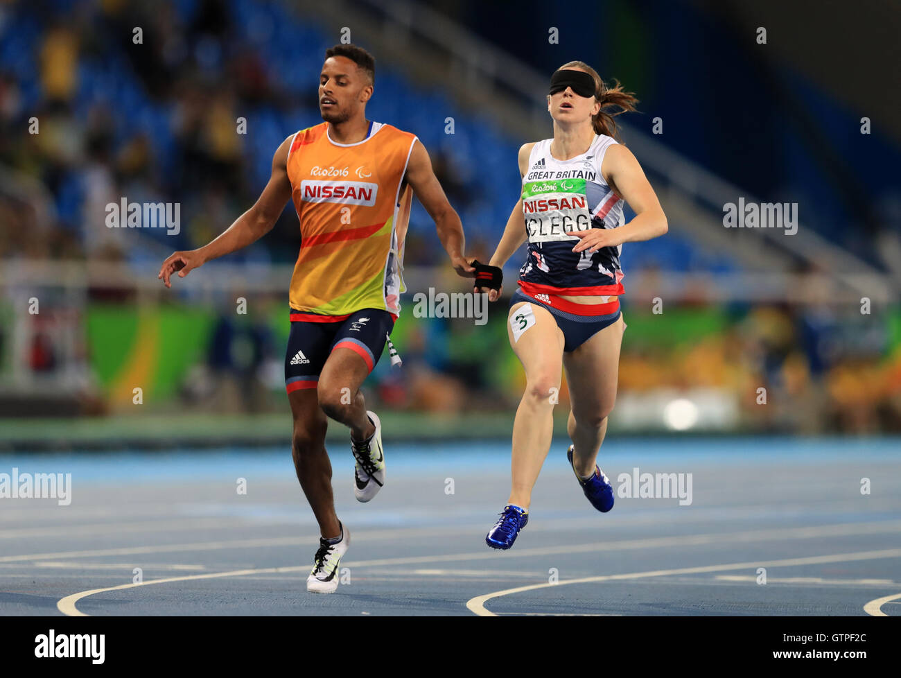 Great Britain's Libby Clegg and guide Chris Clarke celebrate winning ...