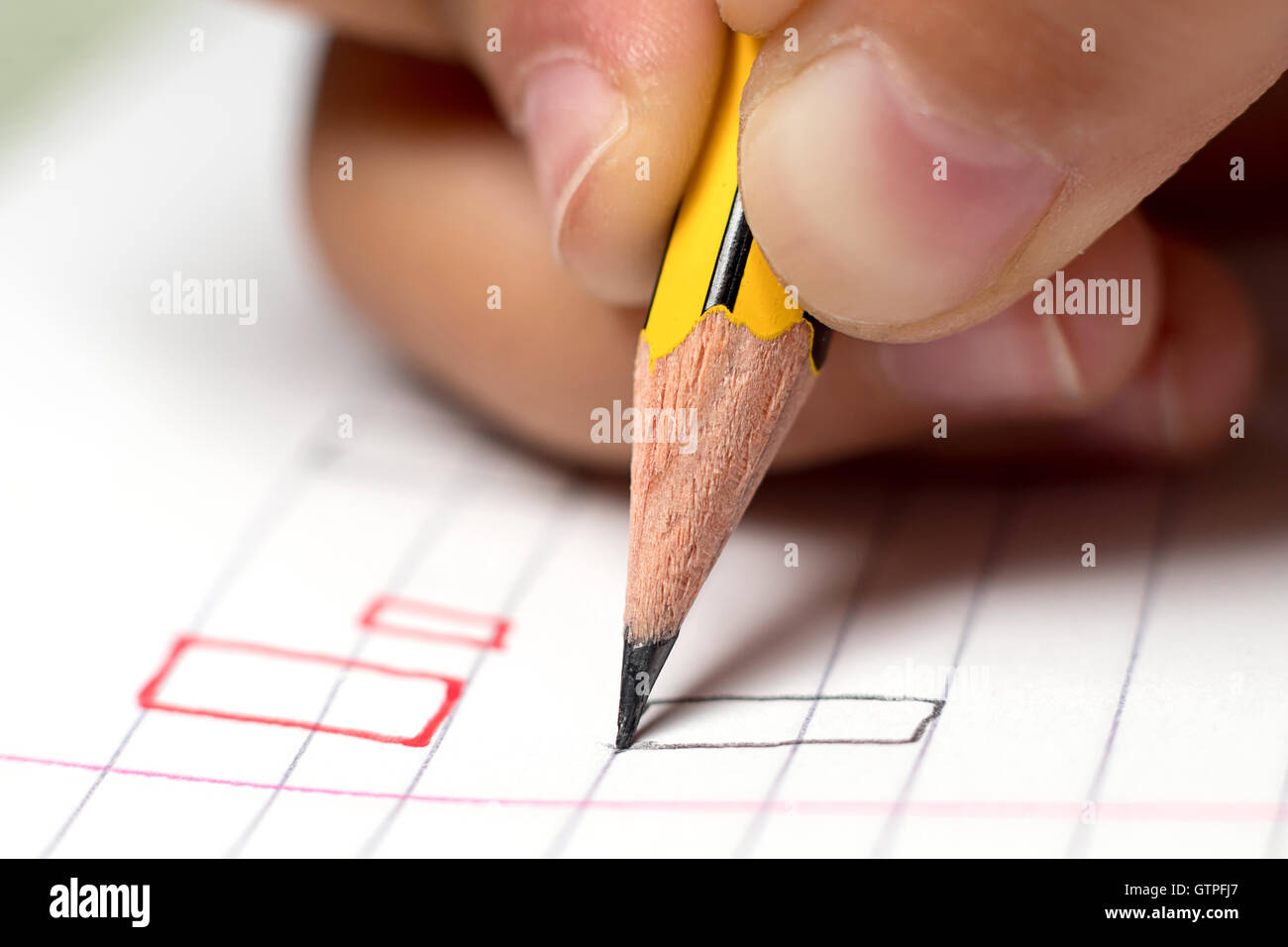 Graphomotor skills. Education concept. The hand writes rectangle. Close ...