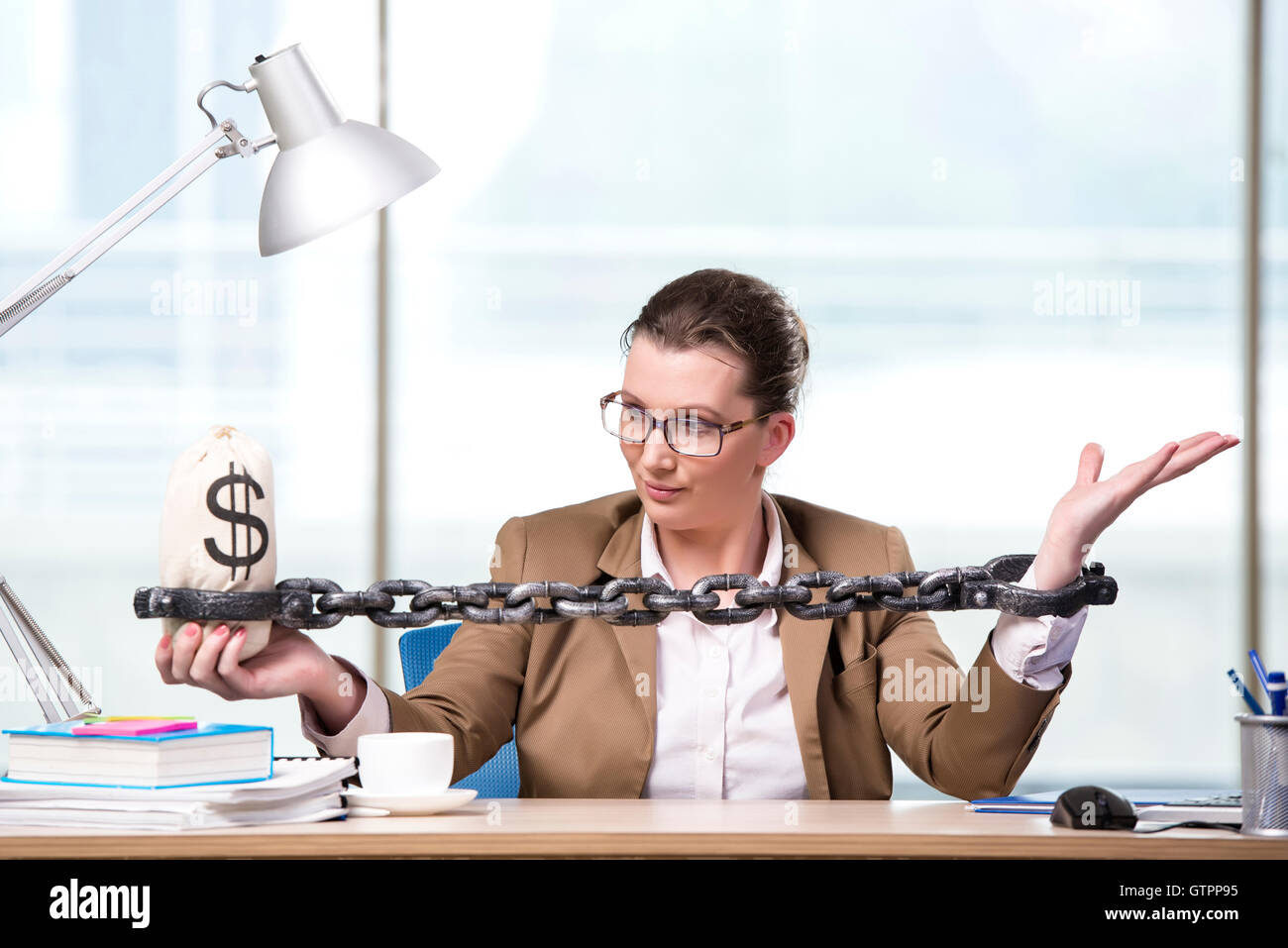 Woman chained working desk hi-res stock photography and images - Alamy