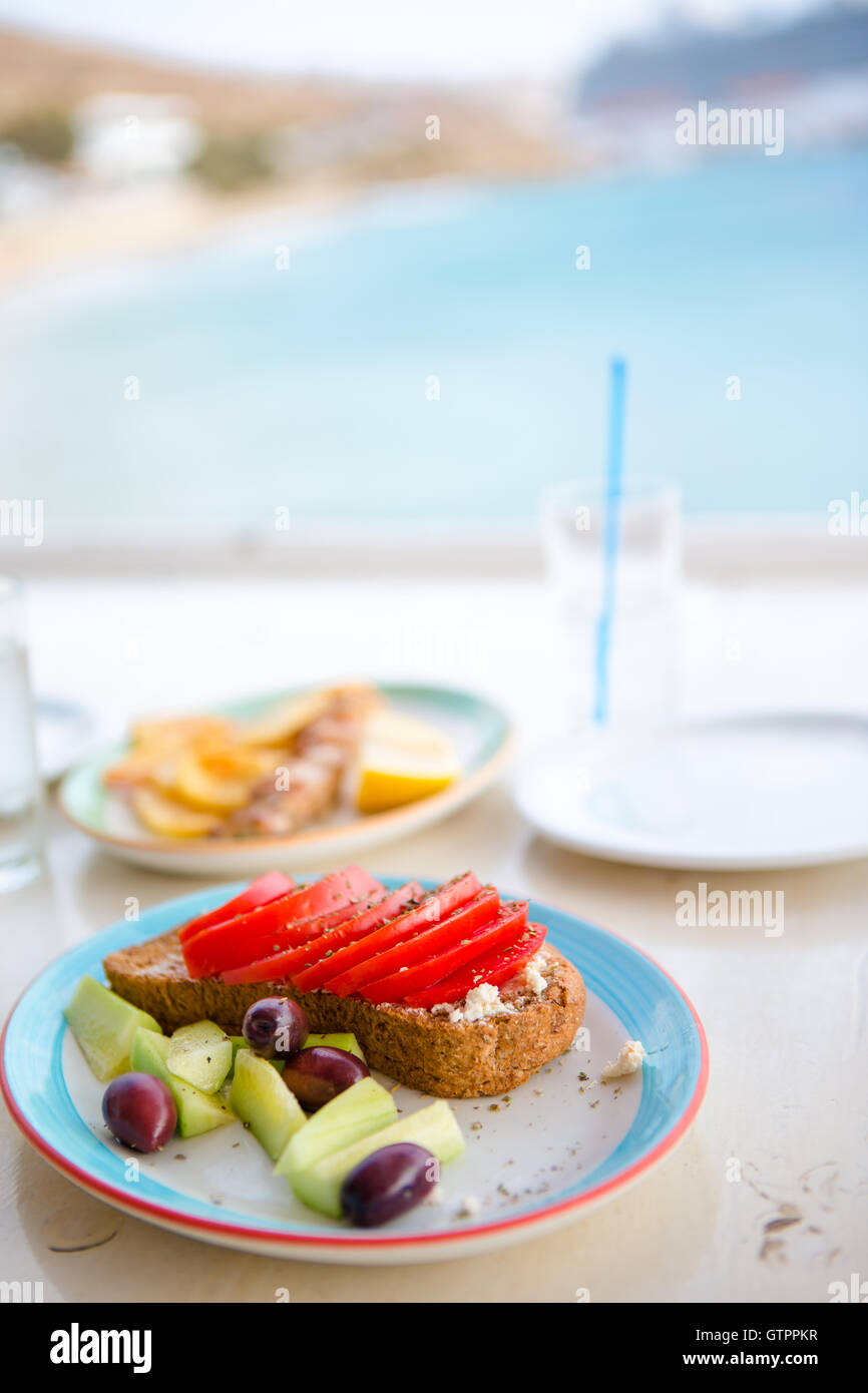 Traditional lunch with delicious fresh greek salad and brusketa served ...