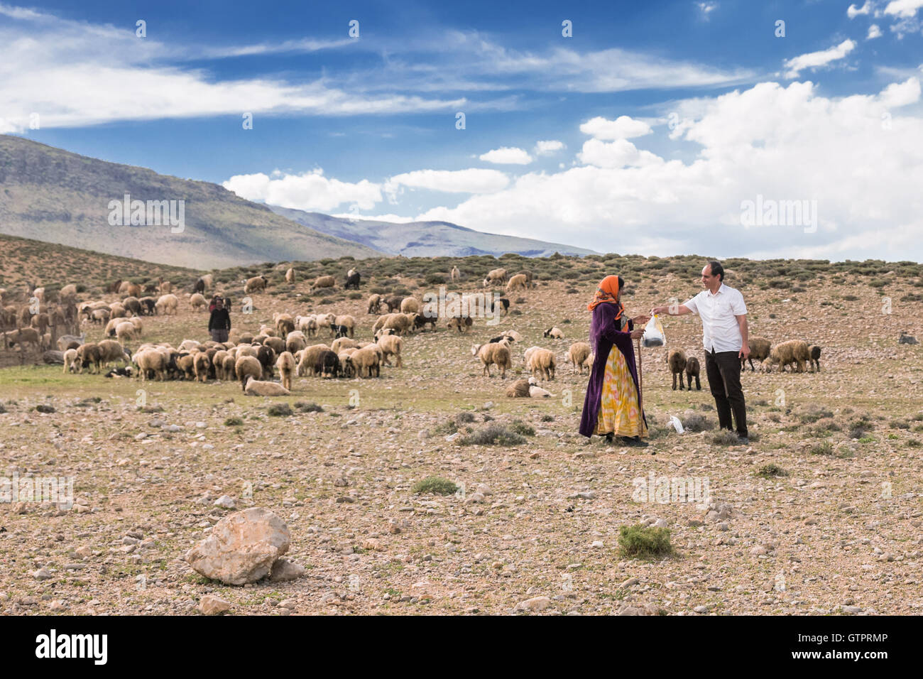 Khoram Gol, nomadic Basseri woman greets a visitor bringing gifts. The ...