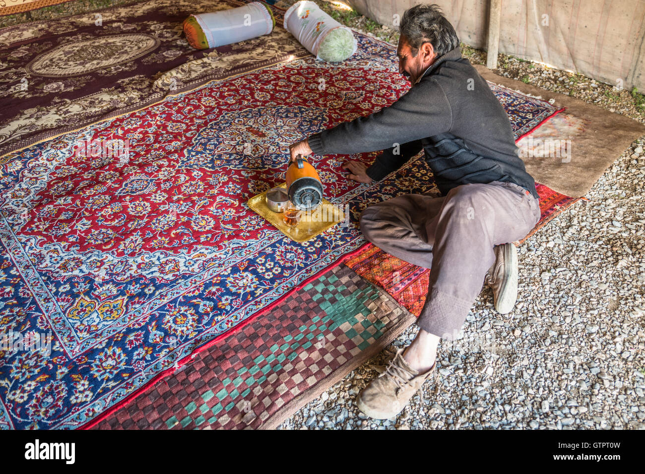 Aziz Gol, nomadic Basseri man, pours tea for his visitors. The Basseri ...