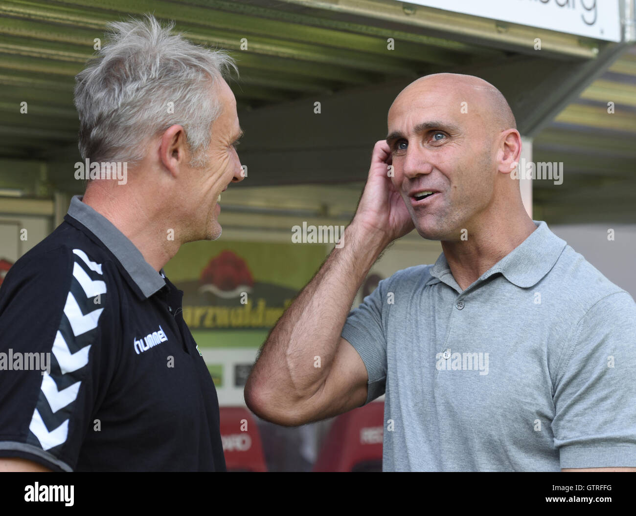 Coach of Freiburg, Christian Streich (l), talks to the coach of ...
