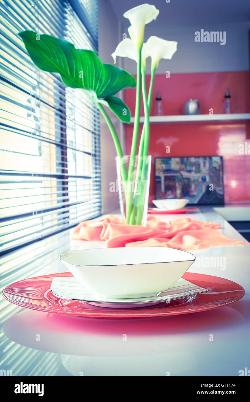 empty clean plates, on table with flowers Stock Photo - Alamy