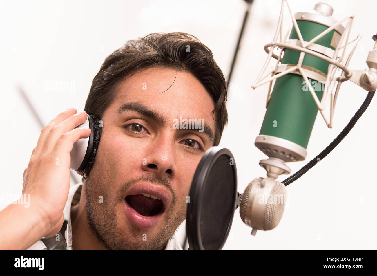 handsome man singing in music studio Stock Photo - Alamy