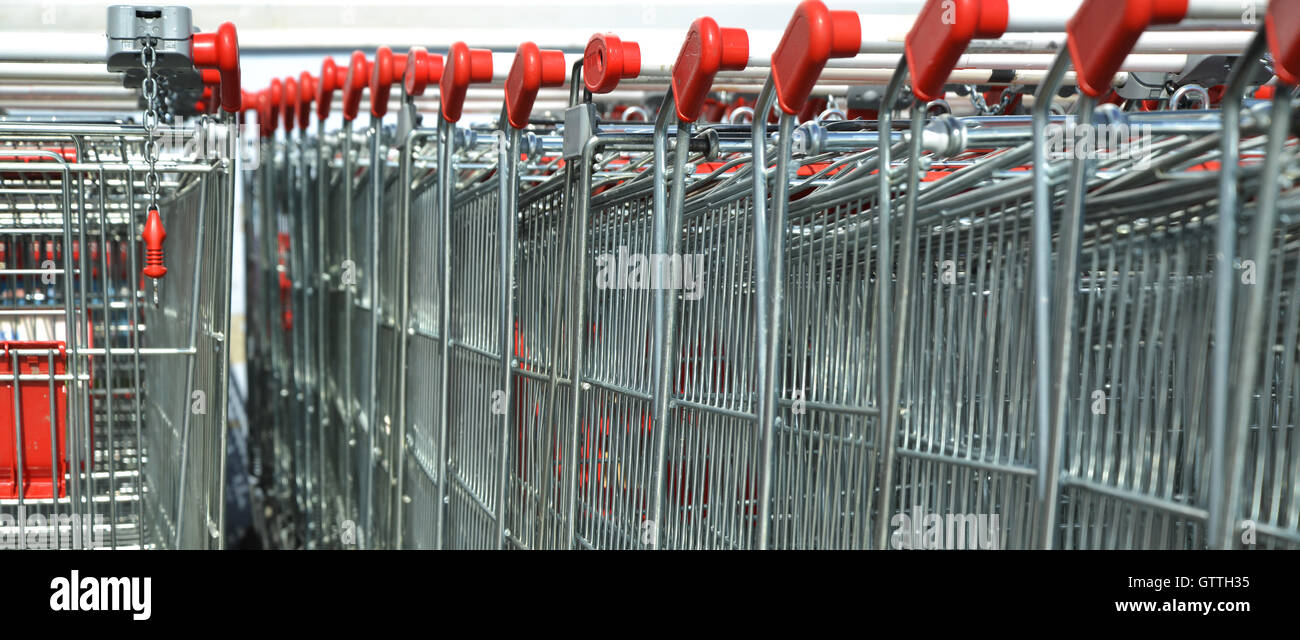 Supermarket trolleys near of mall parking Stock Photo - Alamy