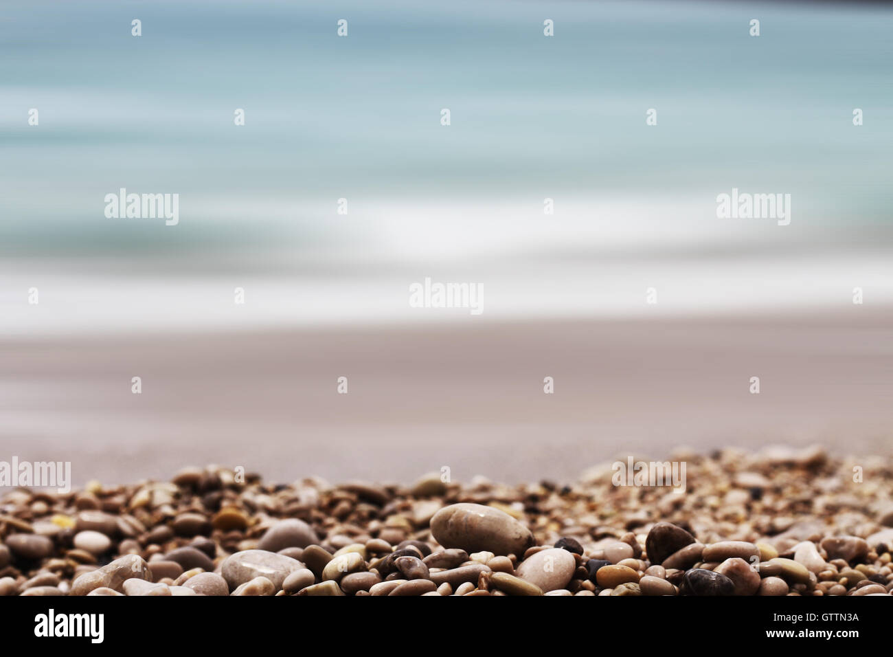 gravel depth of field with sea background theme Stock Photo - Alamy