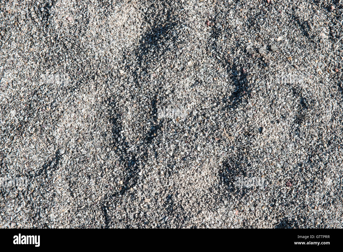 Gray color granite sand texture. Disturbed rugged surface. Play of ...