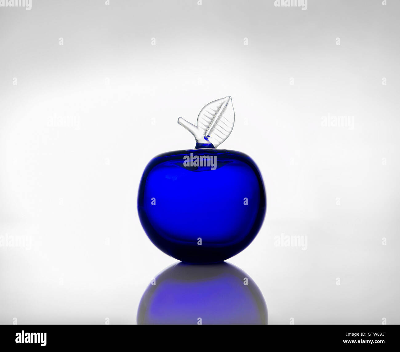 Blue glass apple on white background acrylic Stock Photo - Alamy