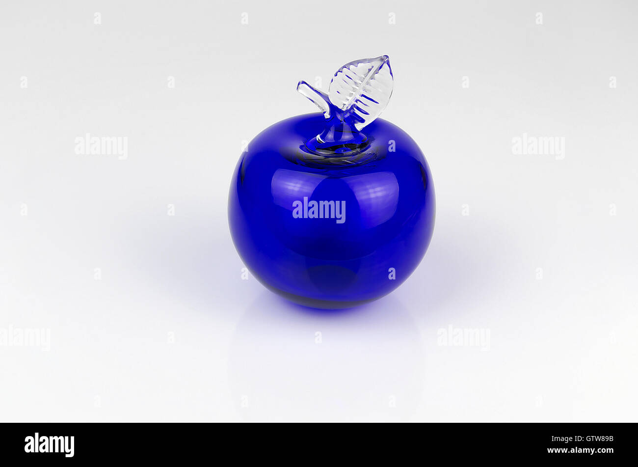 Blue glass apple on white background acrylic Stock Photo - Alamy