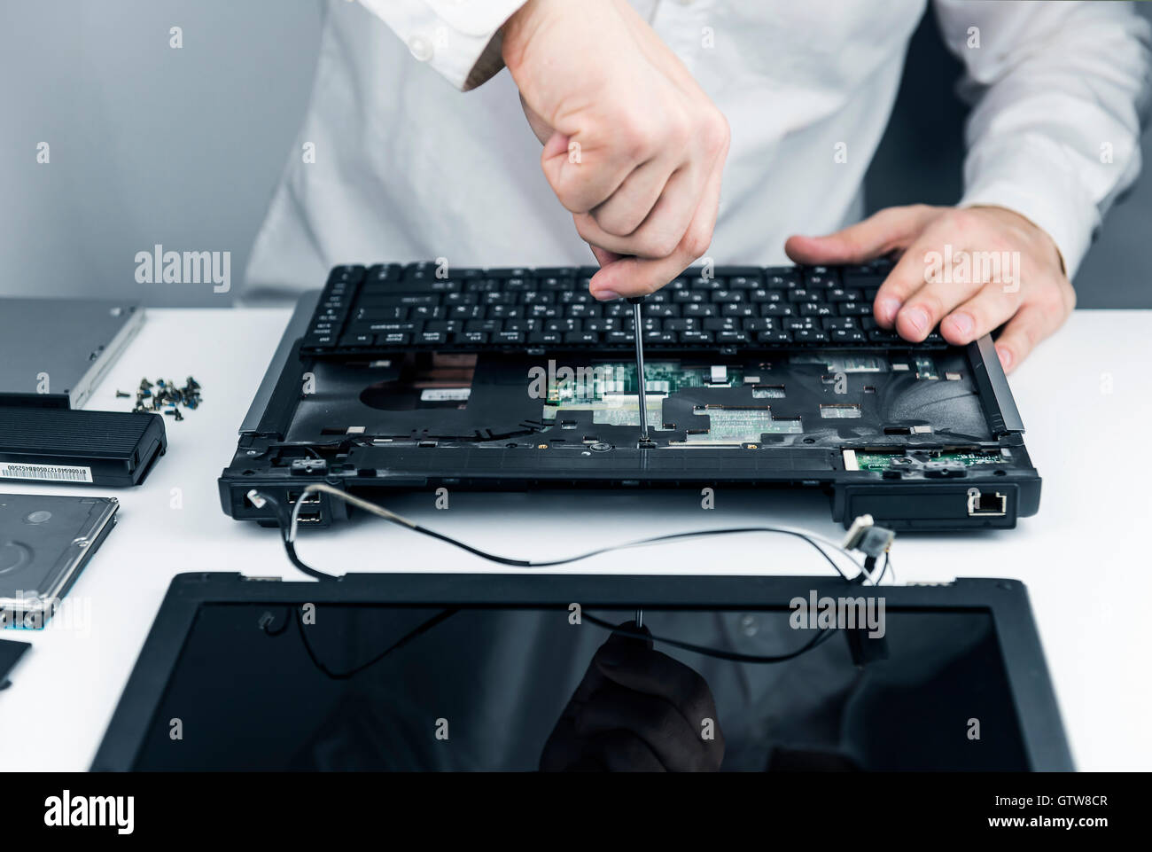 man repair laptop motherboard with screwdriver white coat Stock Photo ...