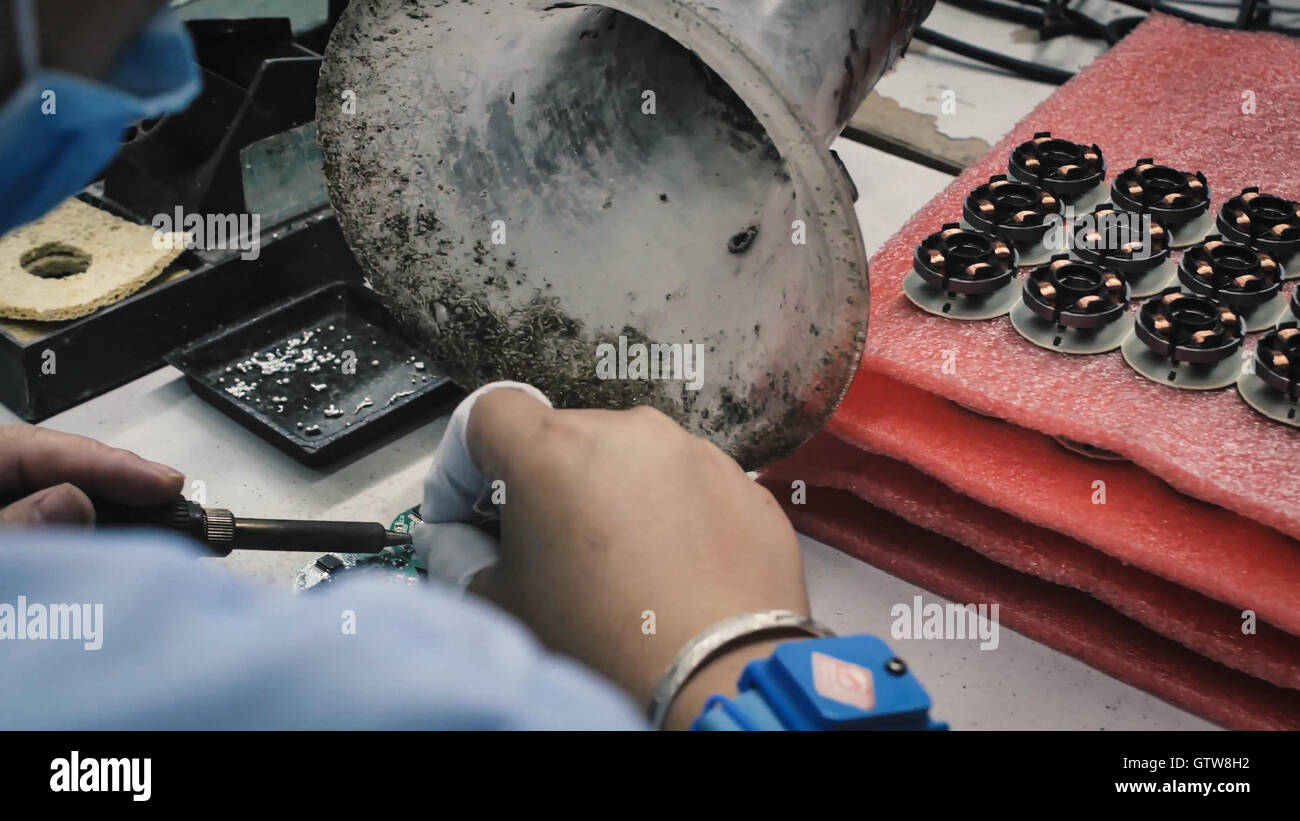 Soldering of electronic components in a factory of computer fans Stock ...