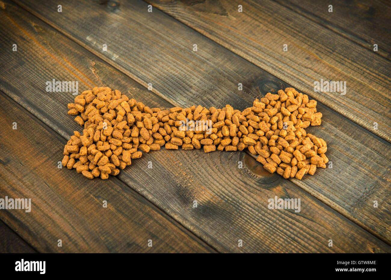 animal bones laid out on wooden background of dry food for dogs and ...