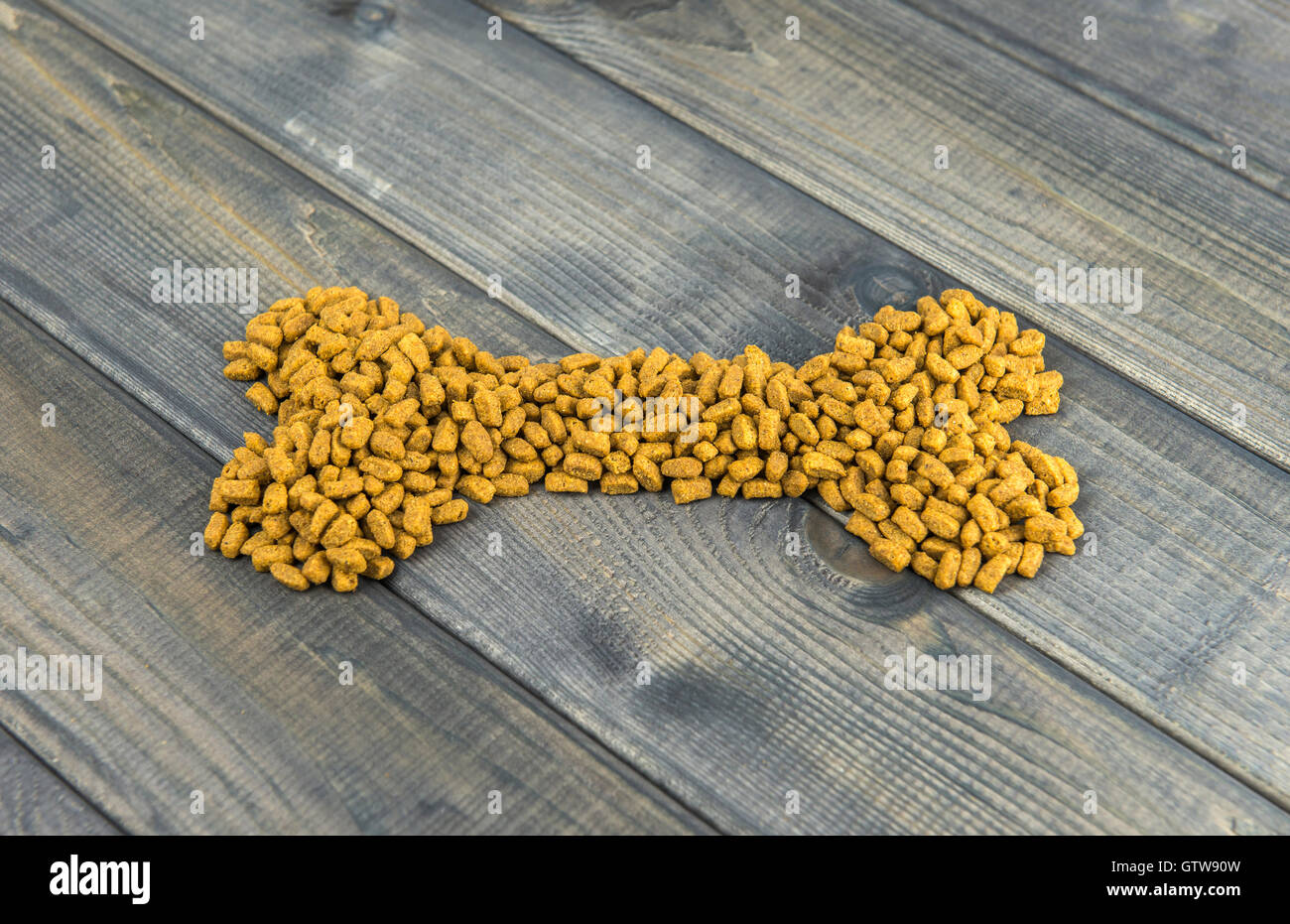 animal bones laid out on wooden background of dry food for dogs and ...