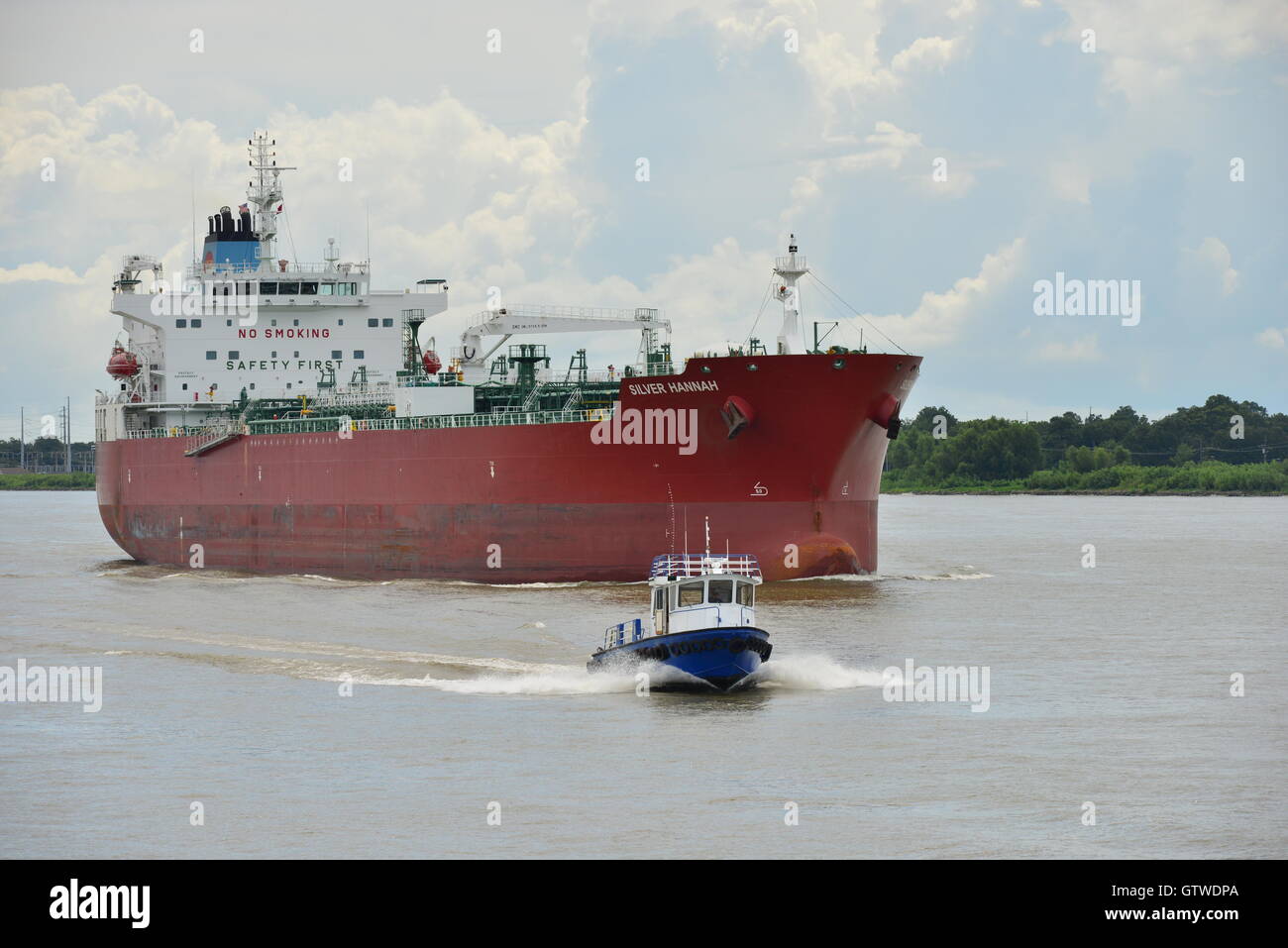 A tanker and a speeding motor launch on the Mississippi river near New ...