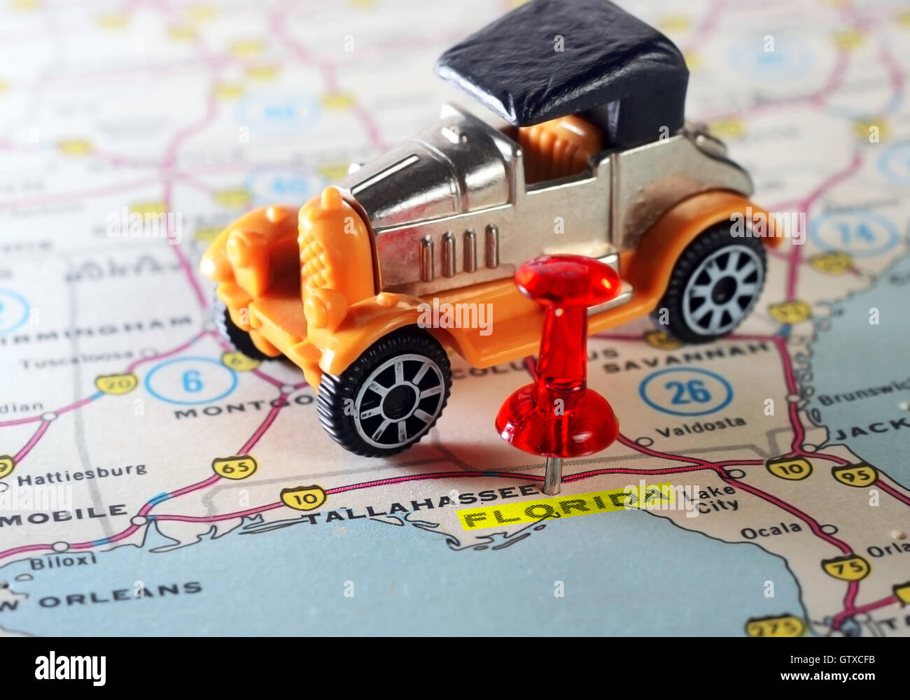 Close up of Florida USA map with red pin and retro car toy - Travel ...