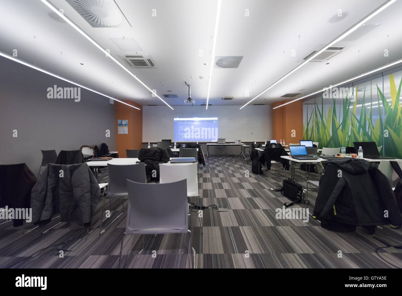 empty it classroom with program code on projector screen and modern ...