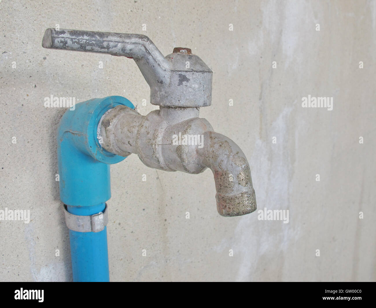Water tap on concrete wall Stock Photo - Alamy
