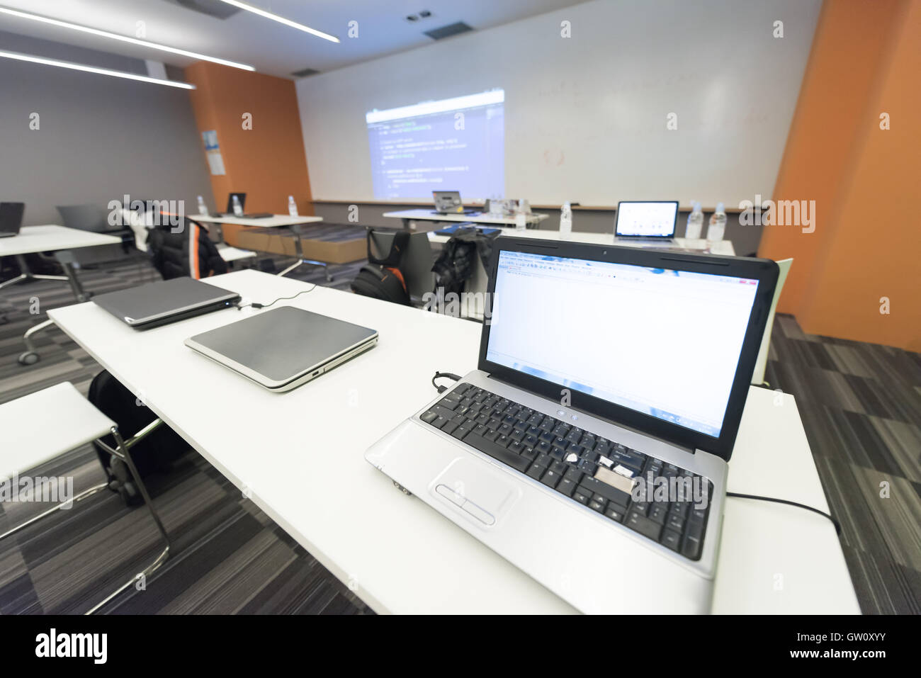 empty it classroom with program code on projector screen and modern ...