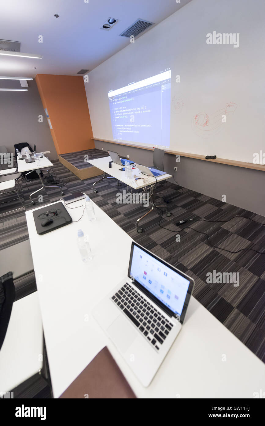 empty it classroom with program code on projector screen and modern ...