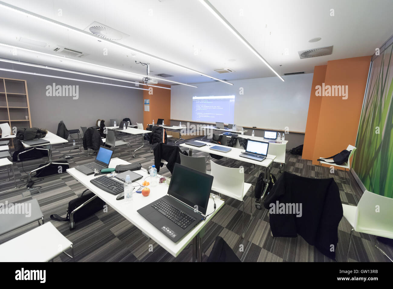 empty it classroom with program code on projector screen and modern ...