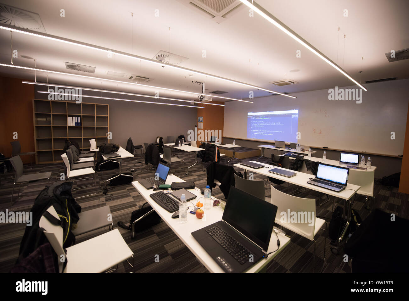 empty it classroom with program code on projector screen and modern ...