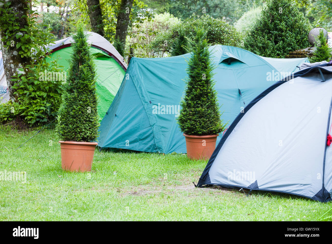 Camping area with tents on green grass lawn Stock Photo - Alamy