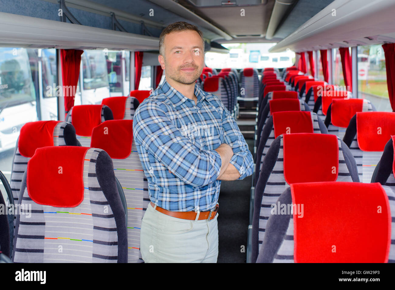 Man stood in coach Stock Photo - Alamy