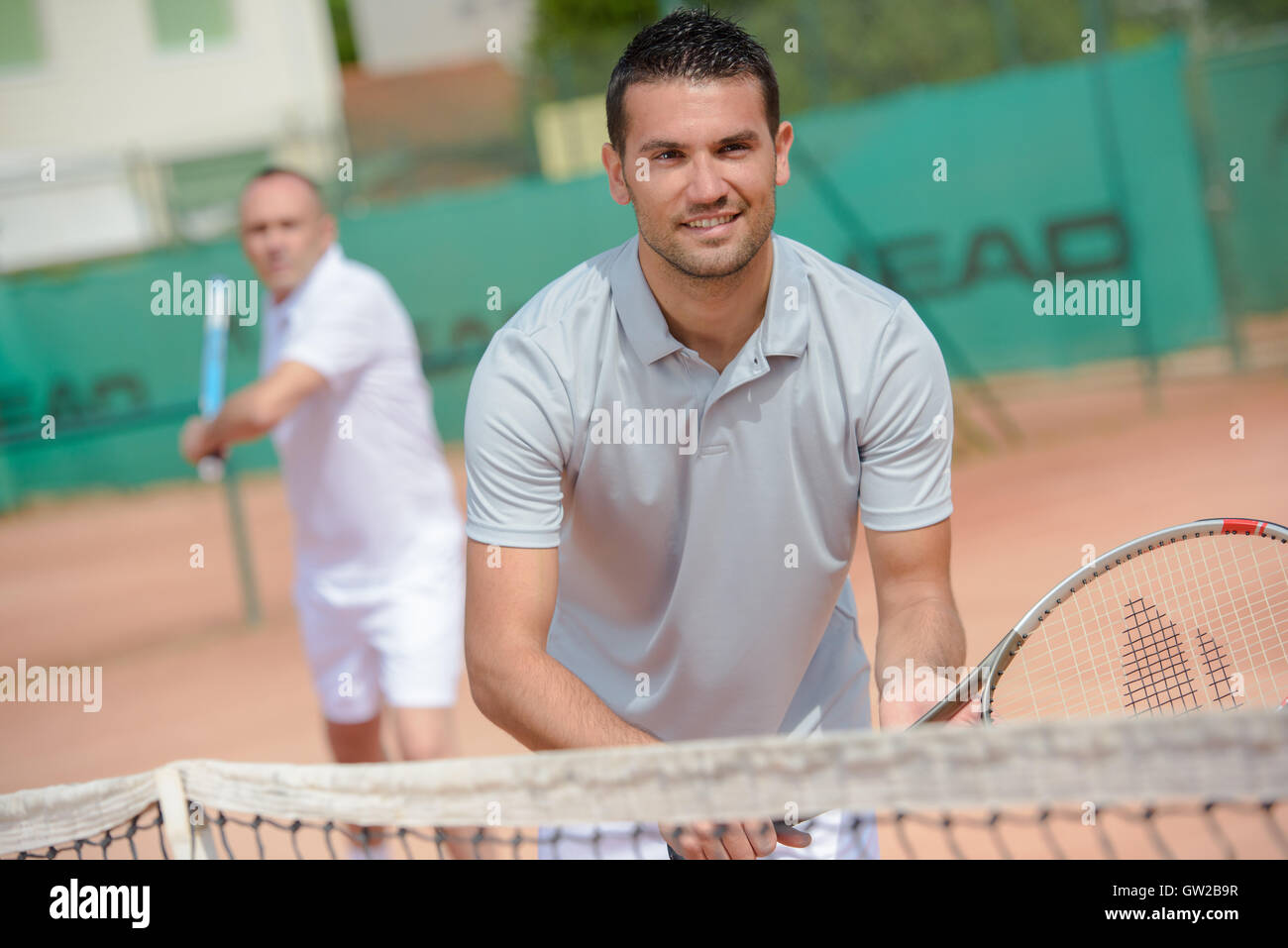 men in the tennis court Stock Photo - Alamy