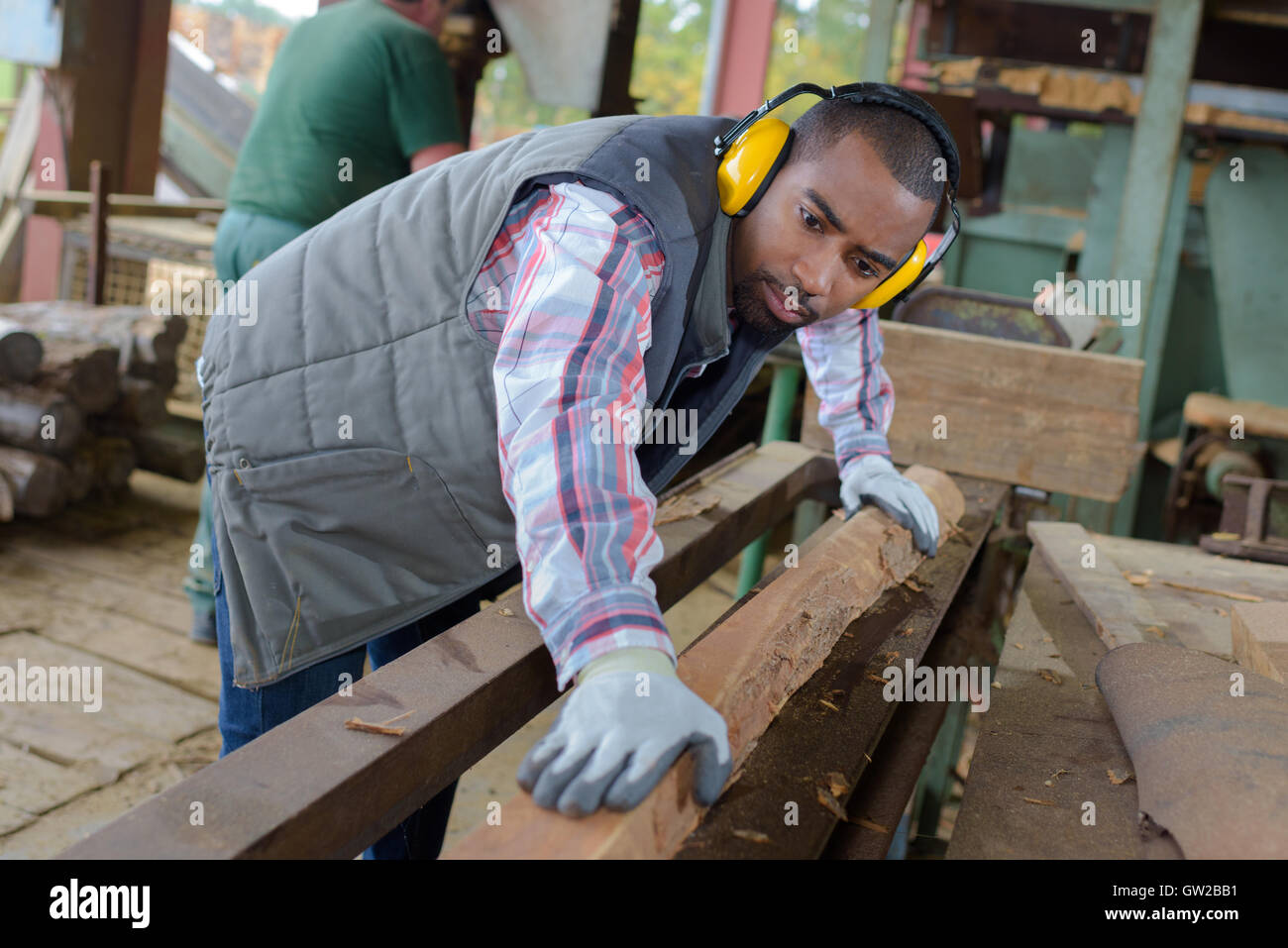 Man at work in sawmill Stock Photo - Alamy