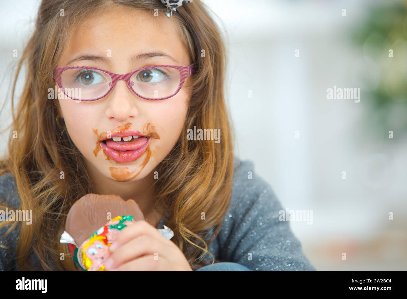 Greedy little girl eating chocolate Stock Photo - Alamy
