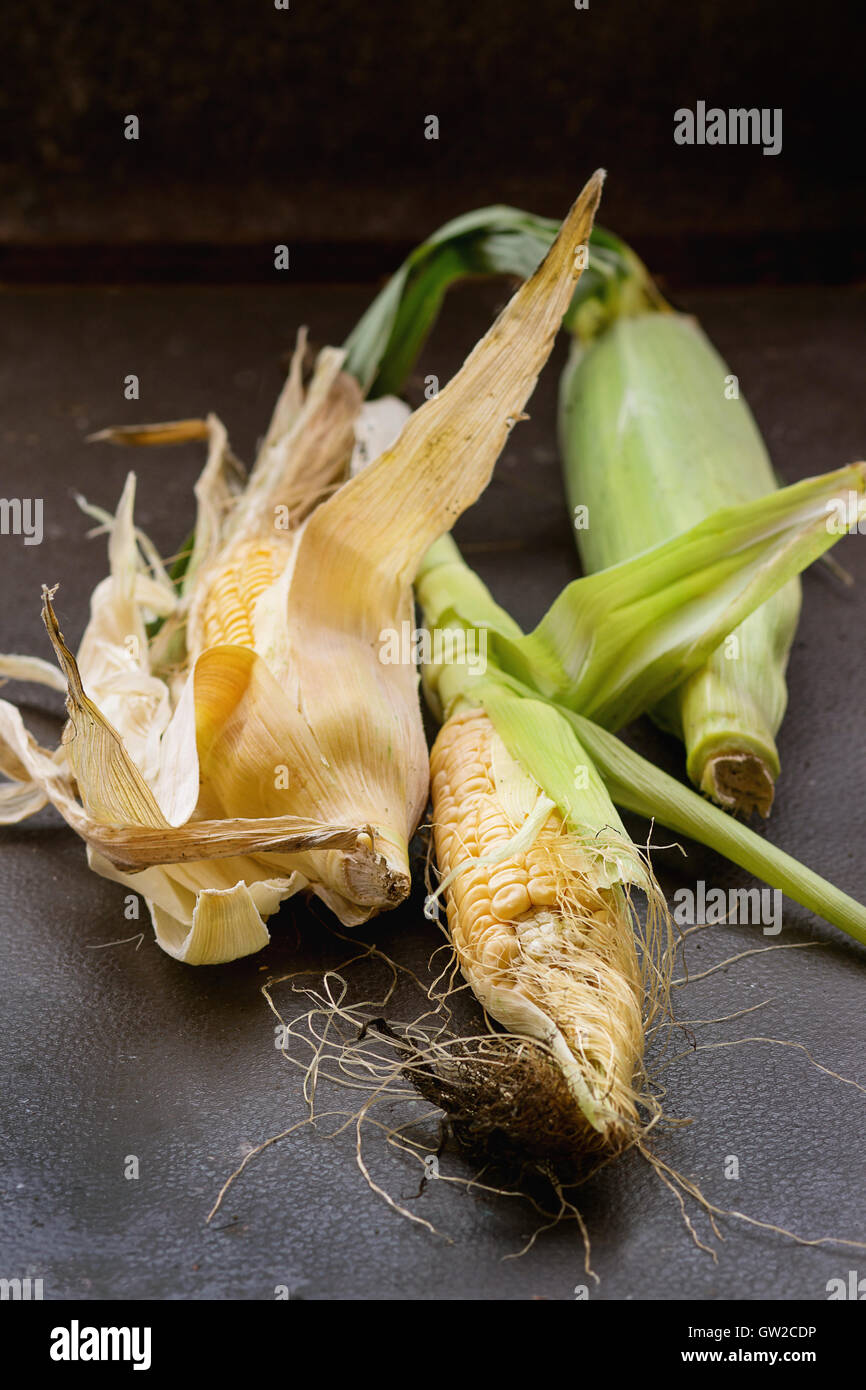 Corn cobs with leaves Stock Photo - Alamy