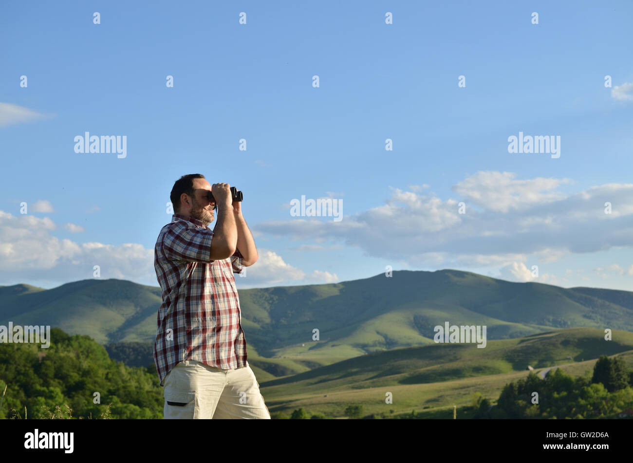 Man watching birds through binoculars hi-res stock photography and ...