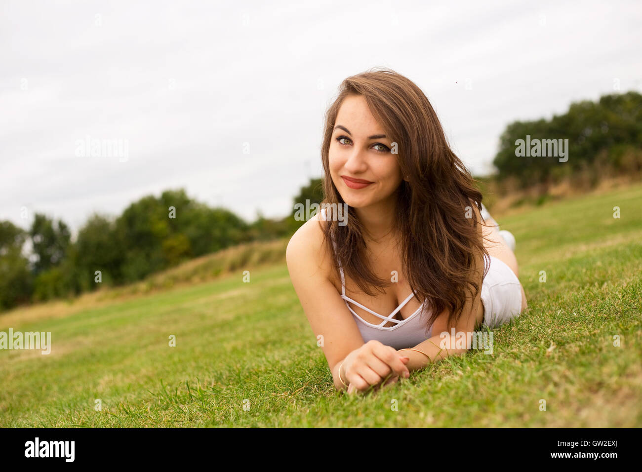 pretty girl lying in the park Stock Photo - Alamy
