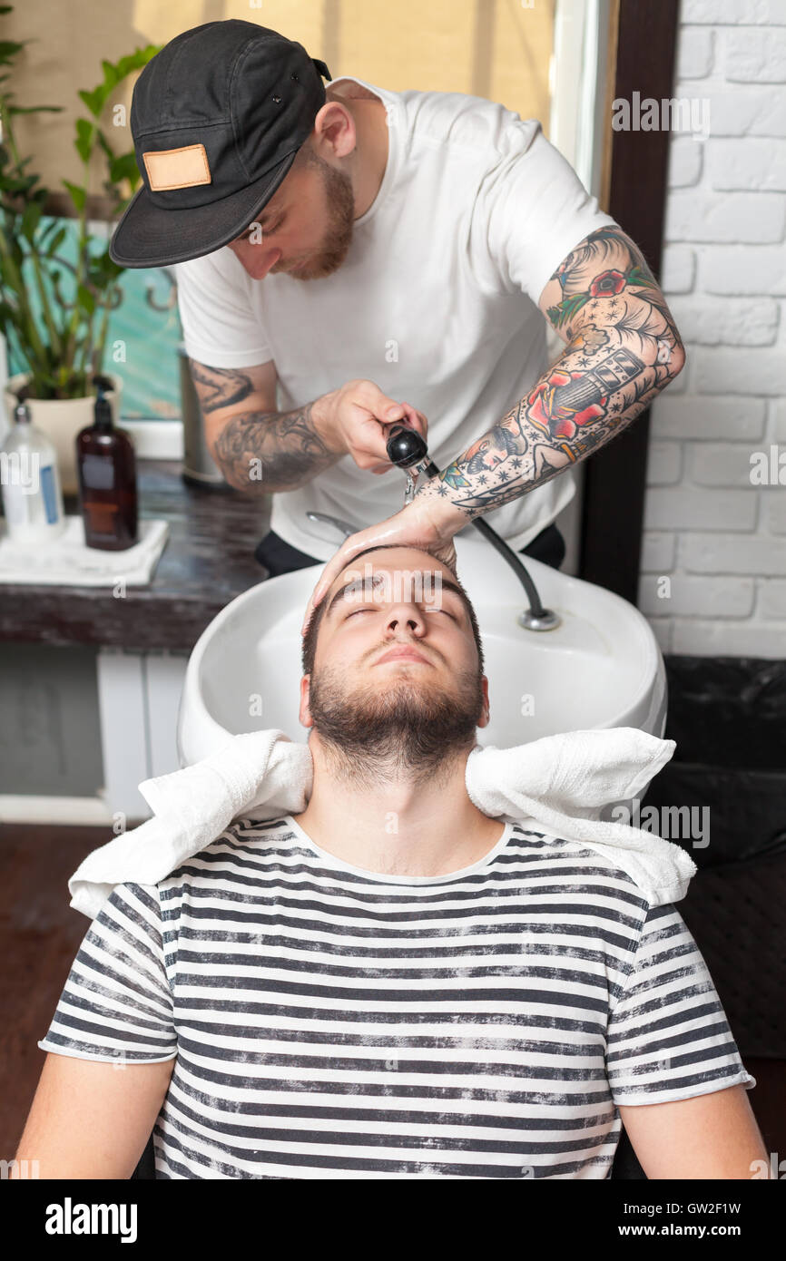 Barber wiping the head of his client with a towel Stock Photo - Alamy