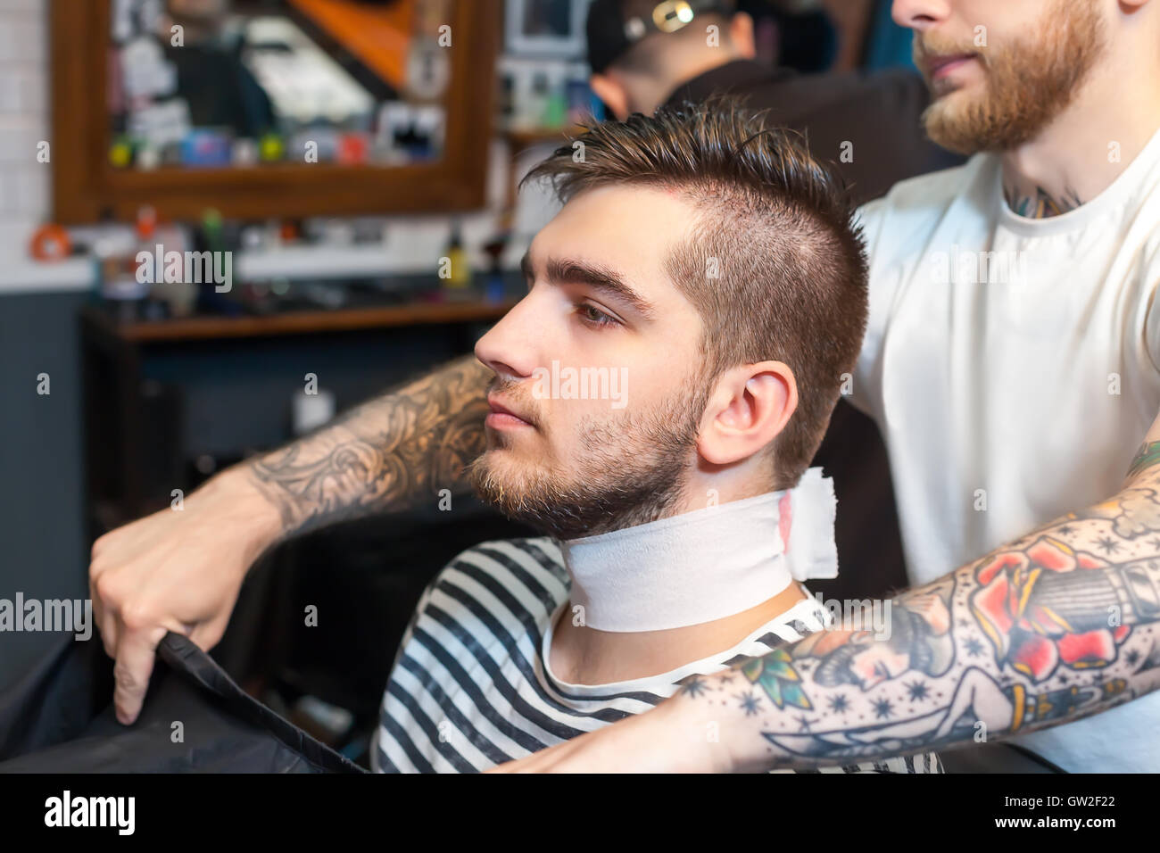 Young man having hair cutted Stock Photo - Alamy