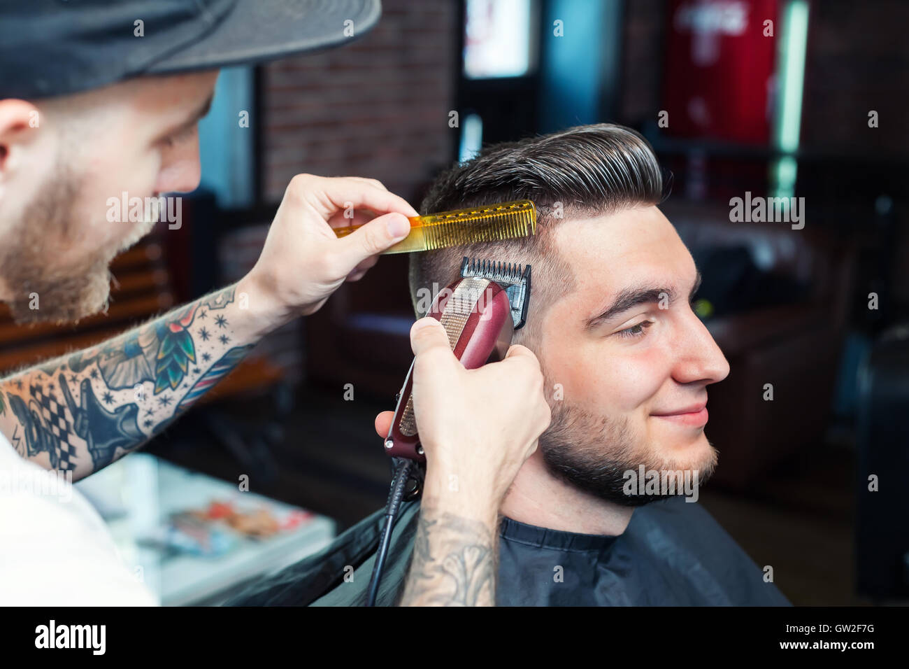 Young man having hair cutted Stock Photo - Alamy