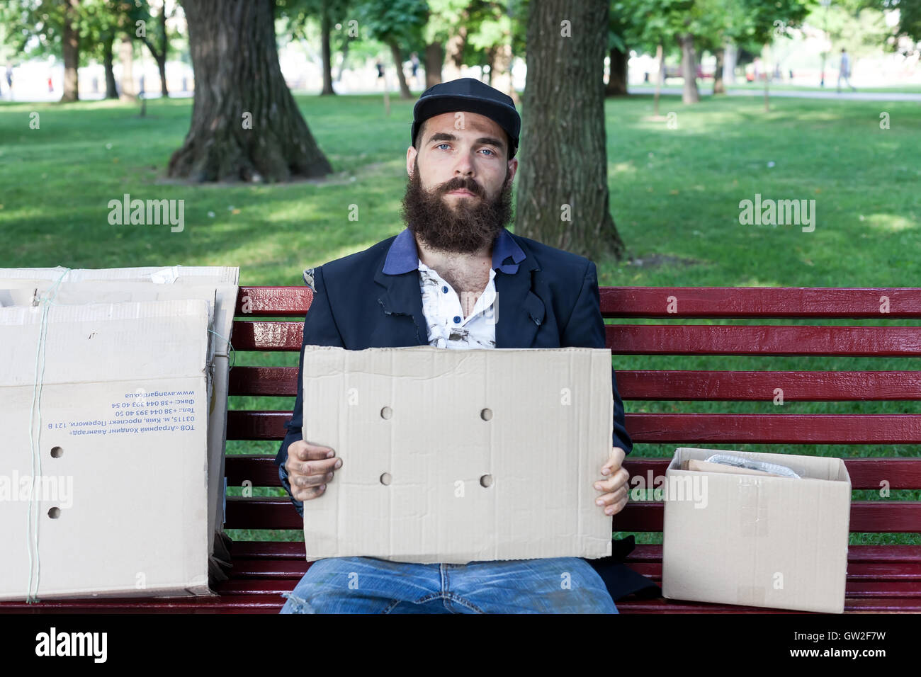 Vagrant with cardboard Stock Photo - Alamy
